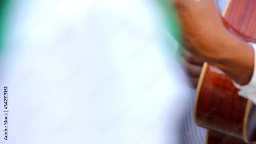 Vídeo do Stock: Closeup on guitar players as person passes by. Local ...