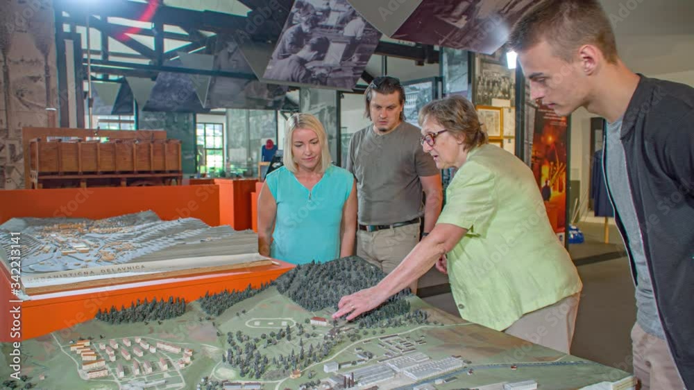Tourists visit iron making museum, steel industry. Model scale of area ...