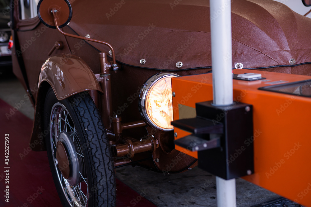 Car repair shop - worker checks and adjusts the headlights of a car's ...