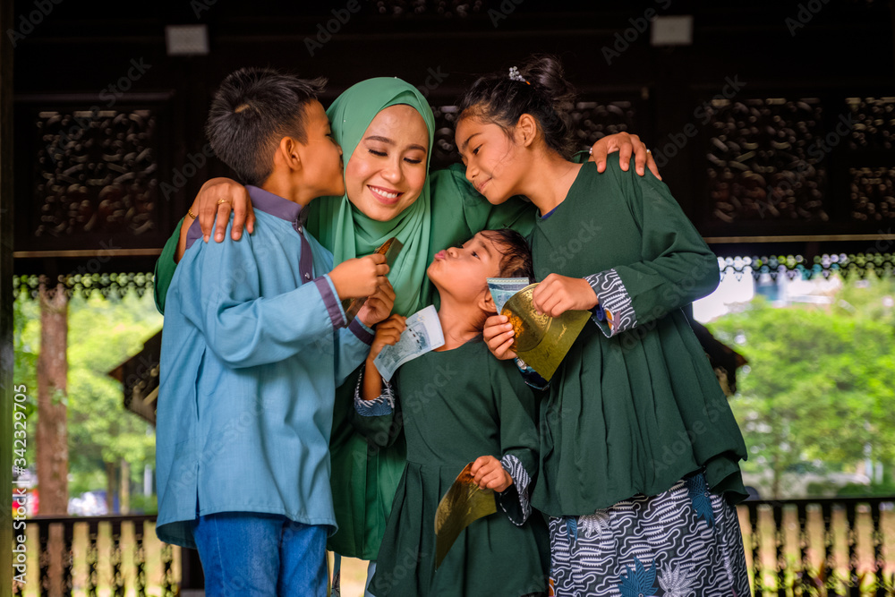 Happy children with an envelope of pocket money or raya angpao are ...