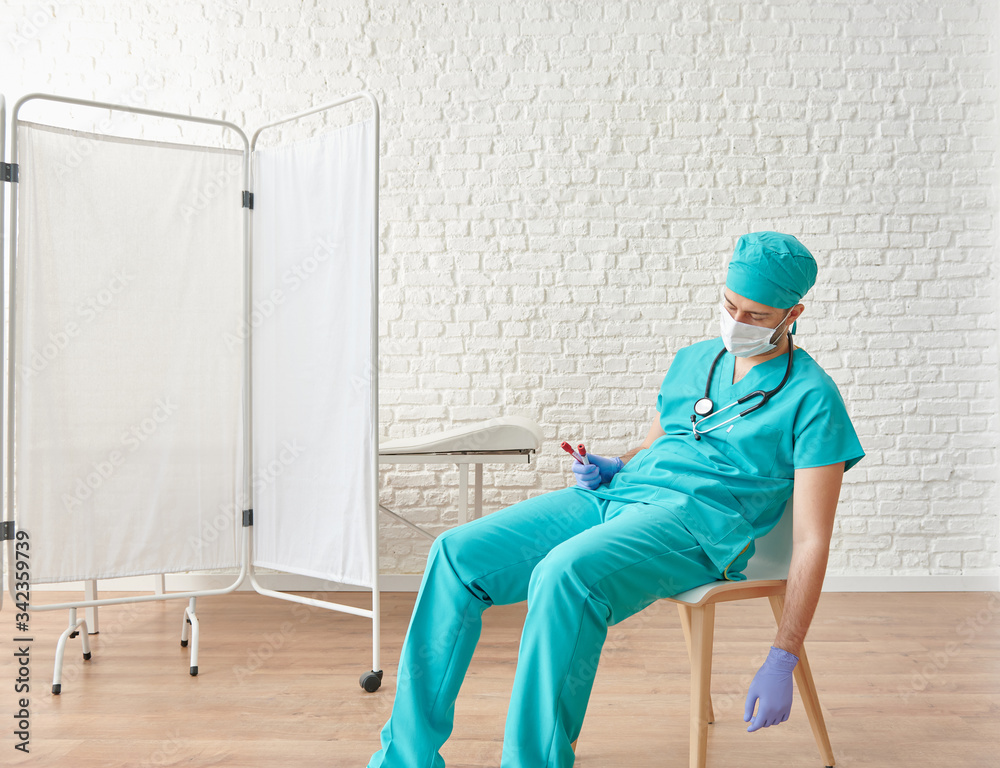 Tired doctor during working hours in the clinic with patient. Stock ...