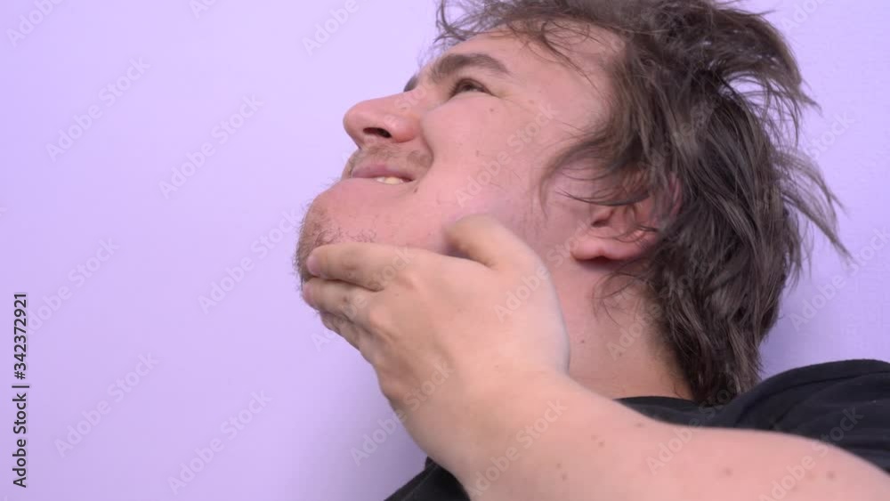 Untidy man with tousled hair and a rare mustache thoughtfully scratches ...