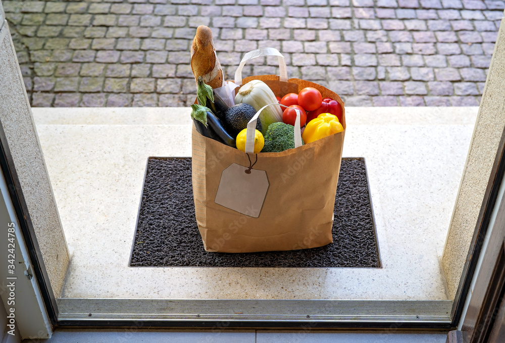 Contactless food delivery service concept. Paper bag with groceries ...