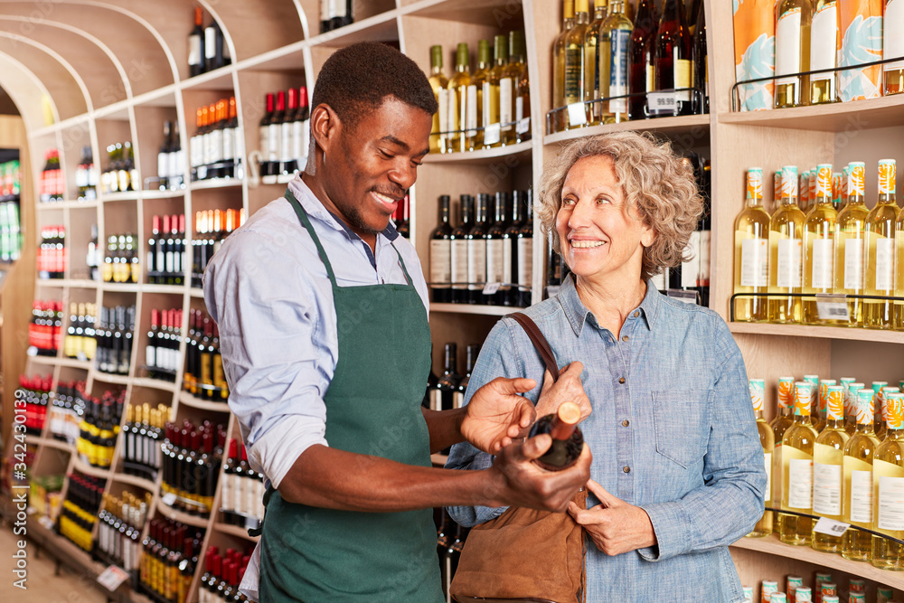Customer buying wine gets advice Stock Photo | Adobe Stock