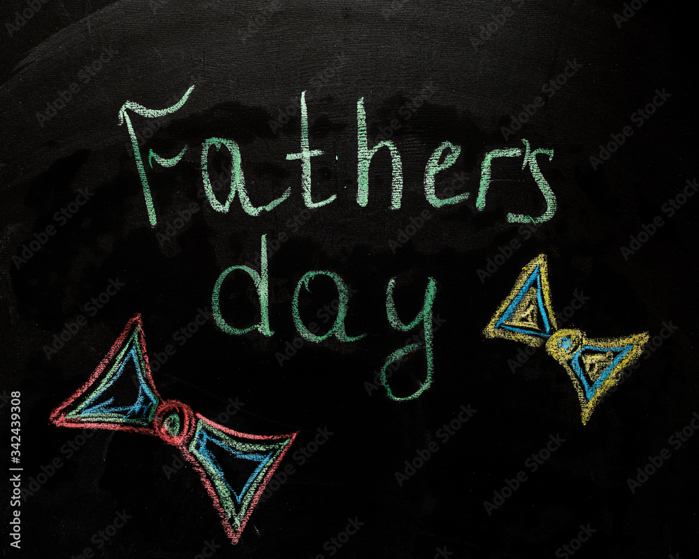 Hand writing fathers day on chalkboard on wood background. Father day ...