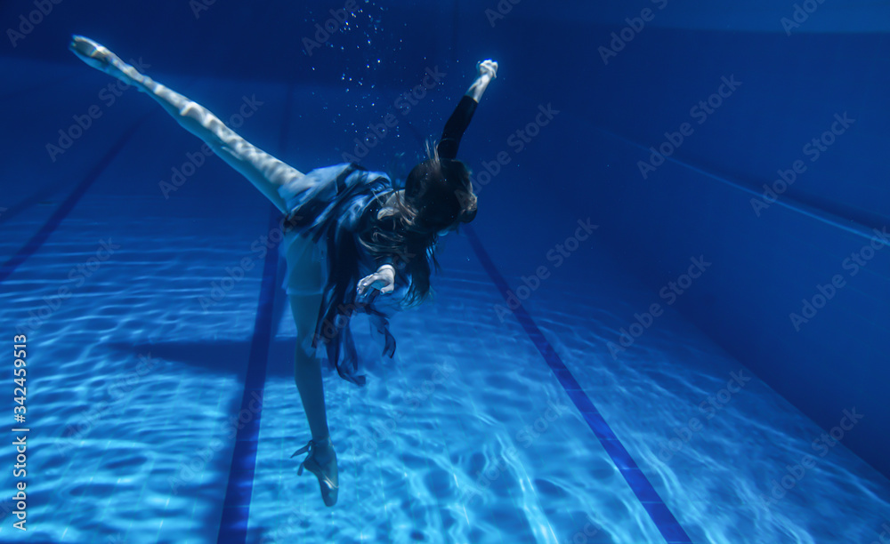 Ballerina jumps into the pool, slender professional dancer under the ...
