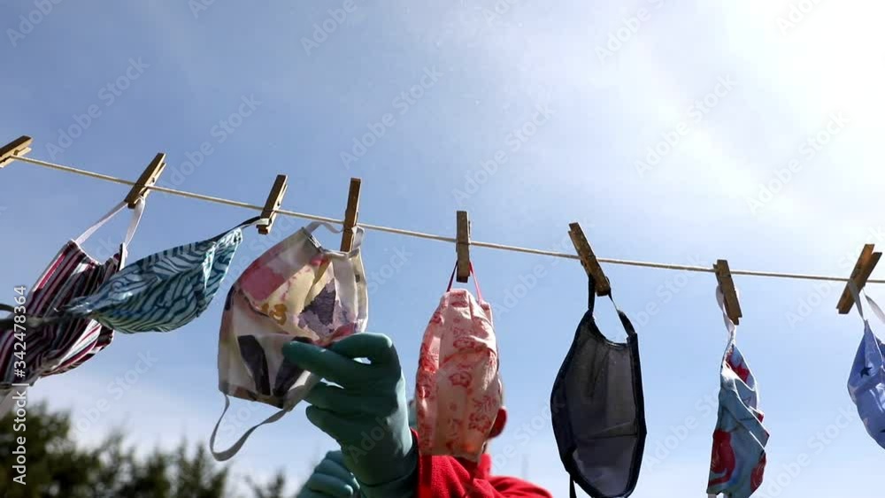 Hygienic mask hanging on the rack outdoor after being washed for ...