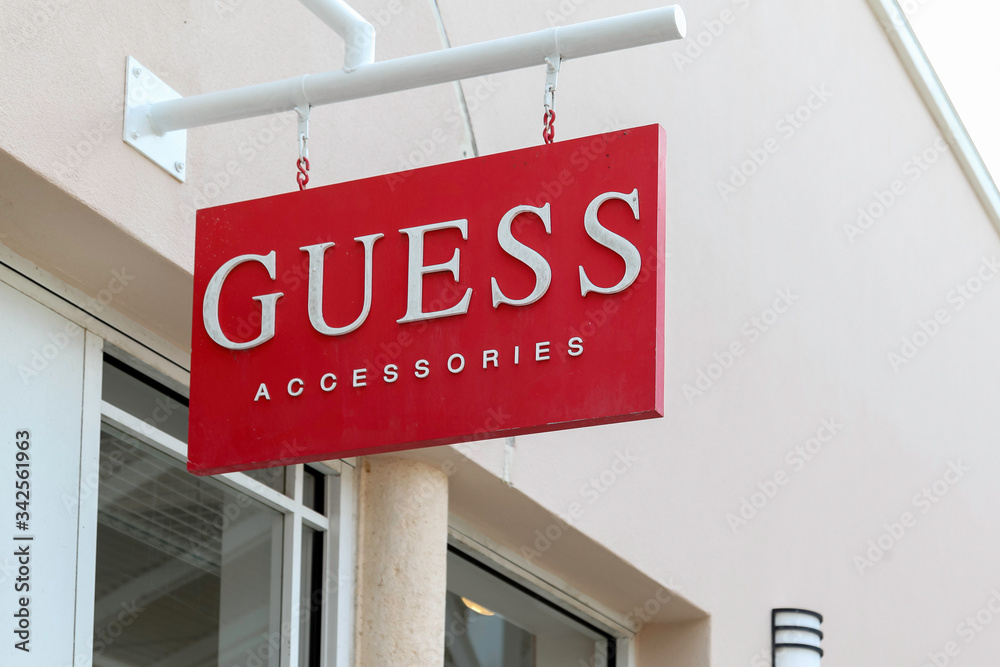 Orlando, Florida, USA- February 24, 2020: Guess store hanging sign in ...