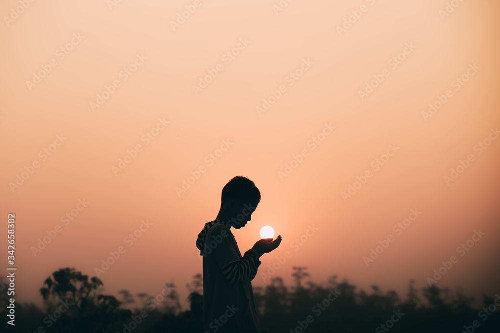 Boy christians praying to God with sun light background, Christians ...