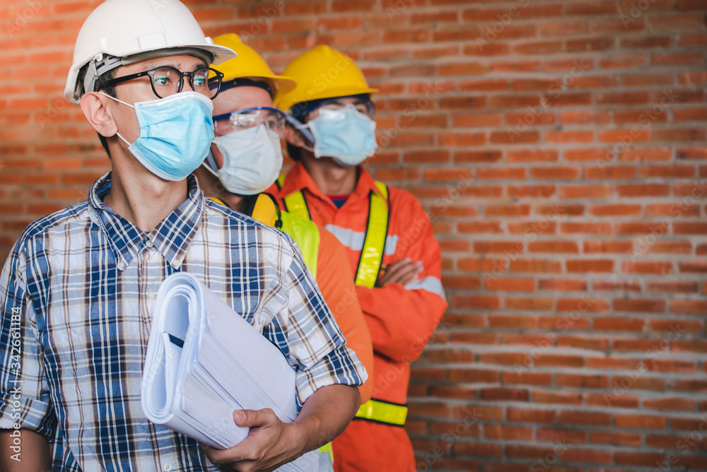 Construction engineers and three architects wear medical masks to ...