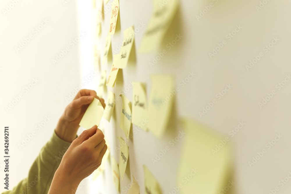 Business people write notes on post paper stickers. Meeting and ...