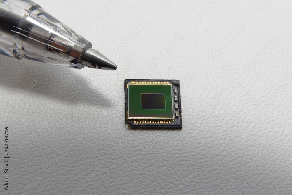 Smartphone camera image sensor compared to the tip of a pen Stock Photo ...