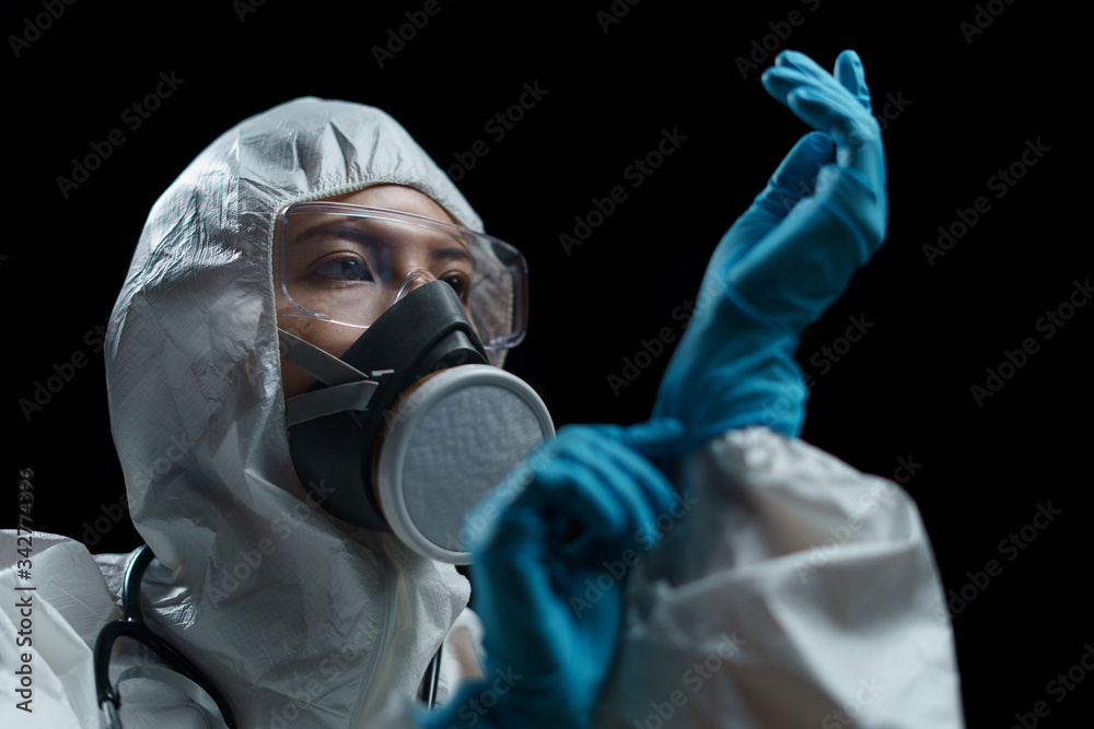 Woman doctor wearing hazmat suits, respirator mask, safety glasses and ...