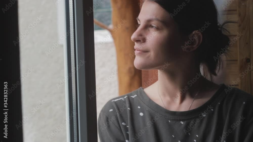 Girl opens a window and takes a breath of fresh air. Female stays at ...