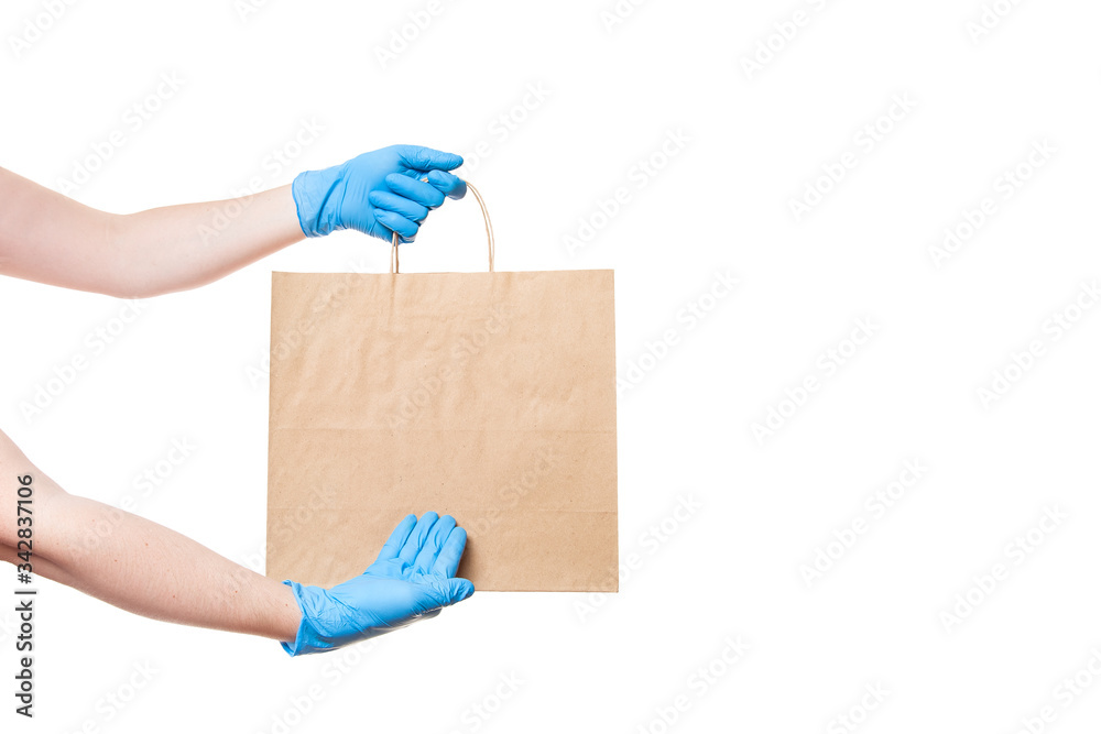 hands in sterile gloves of a courier for safe delivery of food in an ...