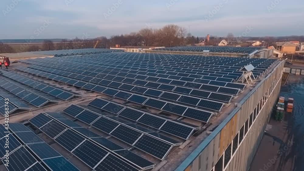Solar panels on rooftop. Aerial view of solar panels on factory roof ...