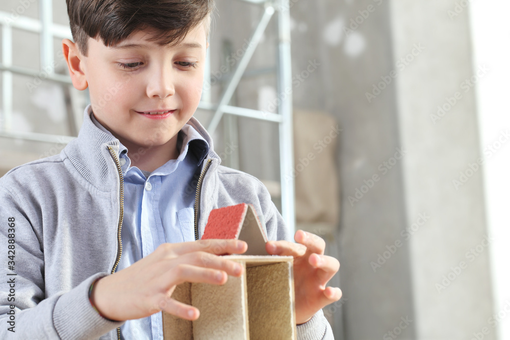 Happy children playing building a house with construction models at ...