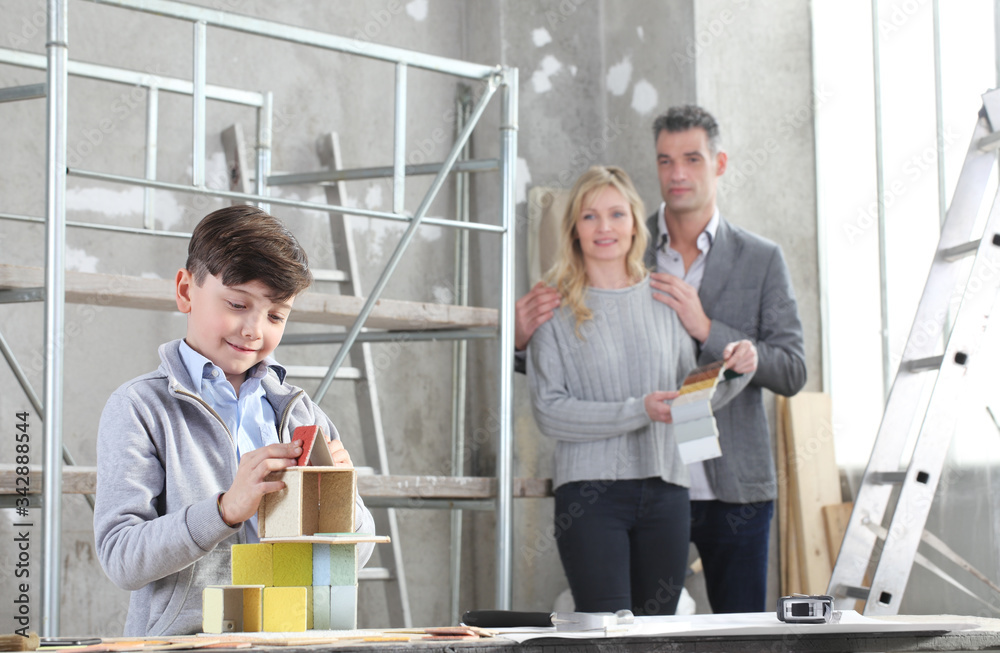 Happy children and his family playing building a house with ...