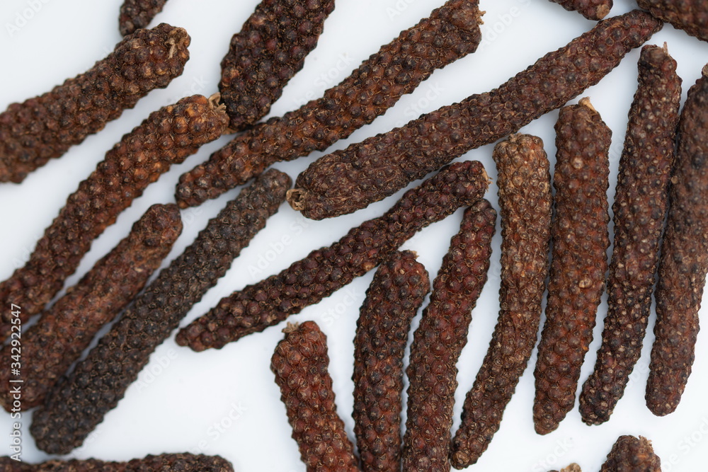 Long pepper or Piper longum on white background Long black pepper (Also ...