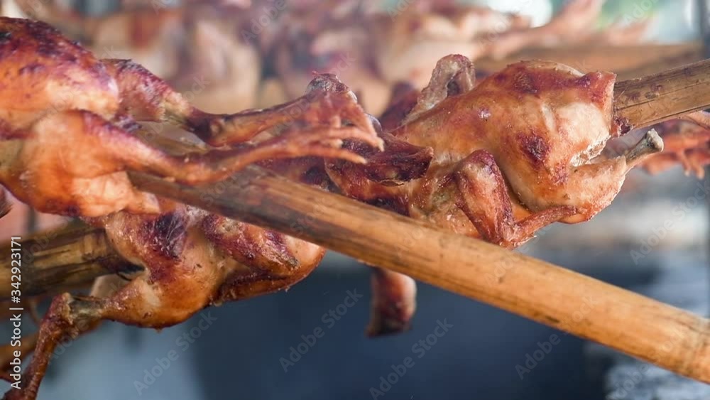 Grilled chicken in barbecue griller. Many tasty chicken body ,legs and ...