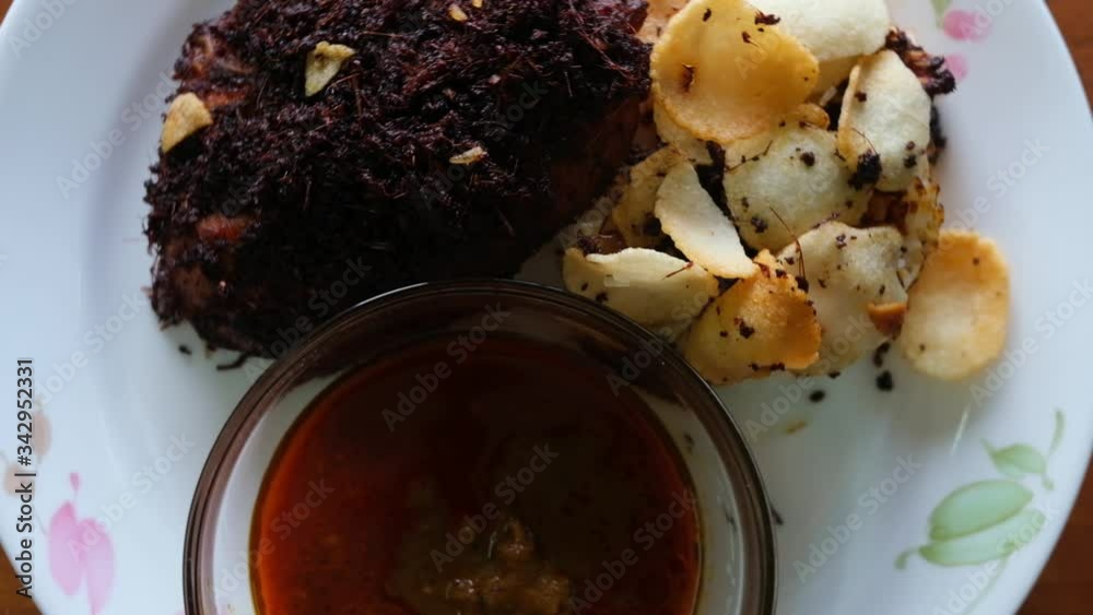 Rotating "nasi kukus" or steam rice serve with traditional herbs ...