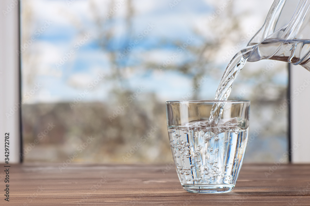 water pouring from jug into glass Stock Photo | Adobe Stock