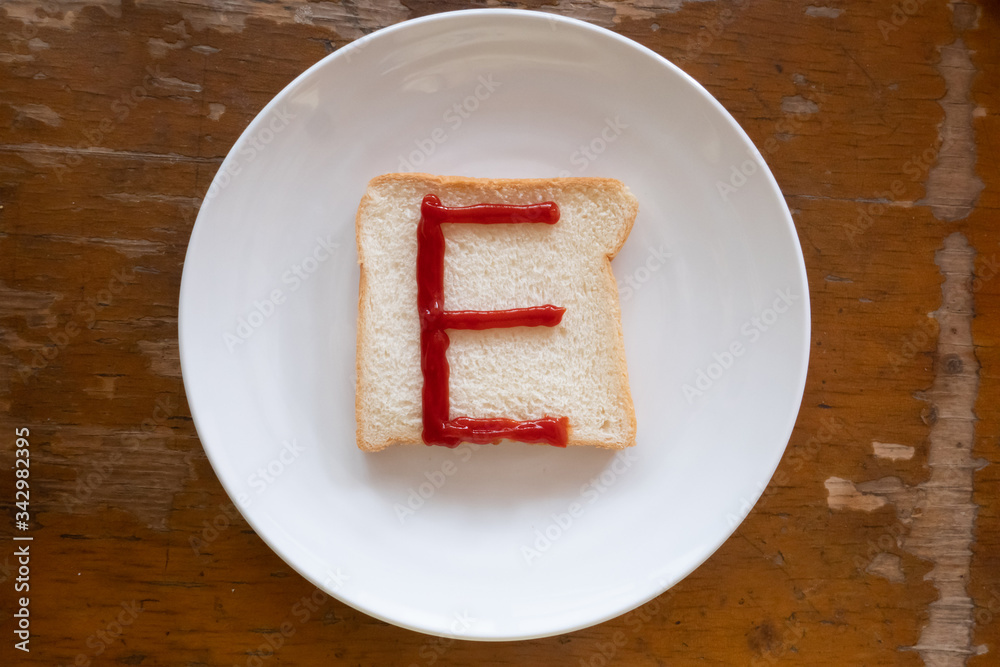 bread of breakfast is written E by ketchup on write plate. A to Z and ...