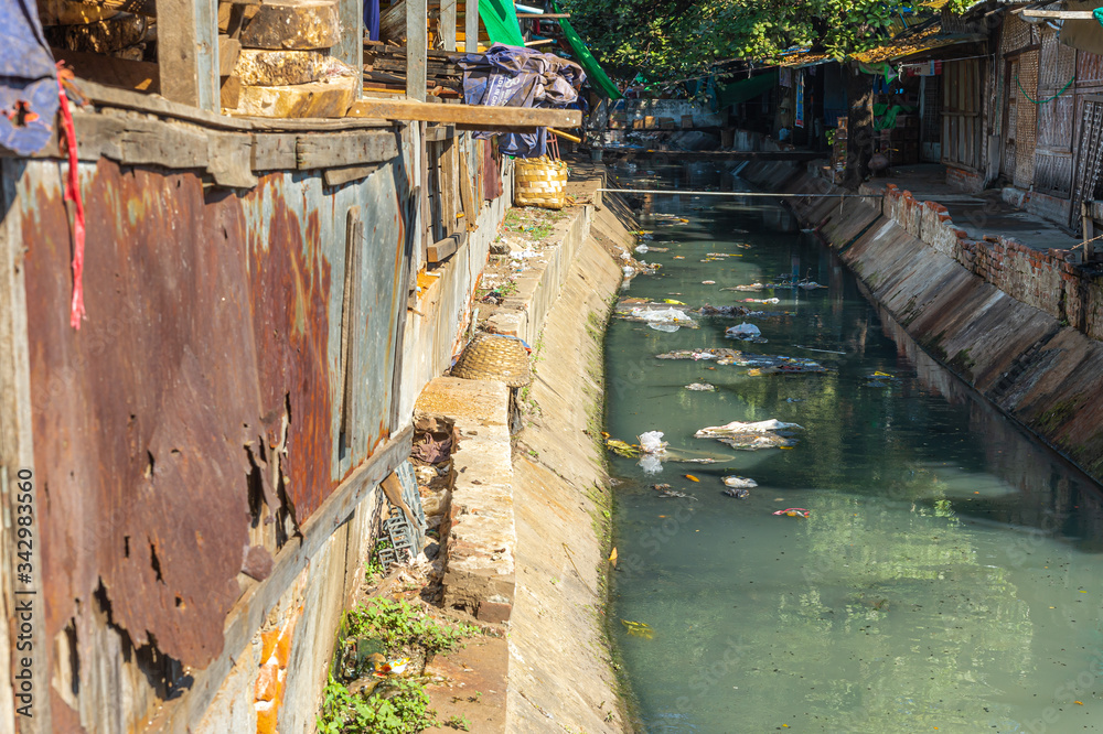 Many rubbishes were thrown into a concrete canal causing bad pollution ...