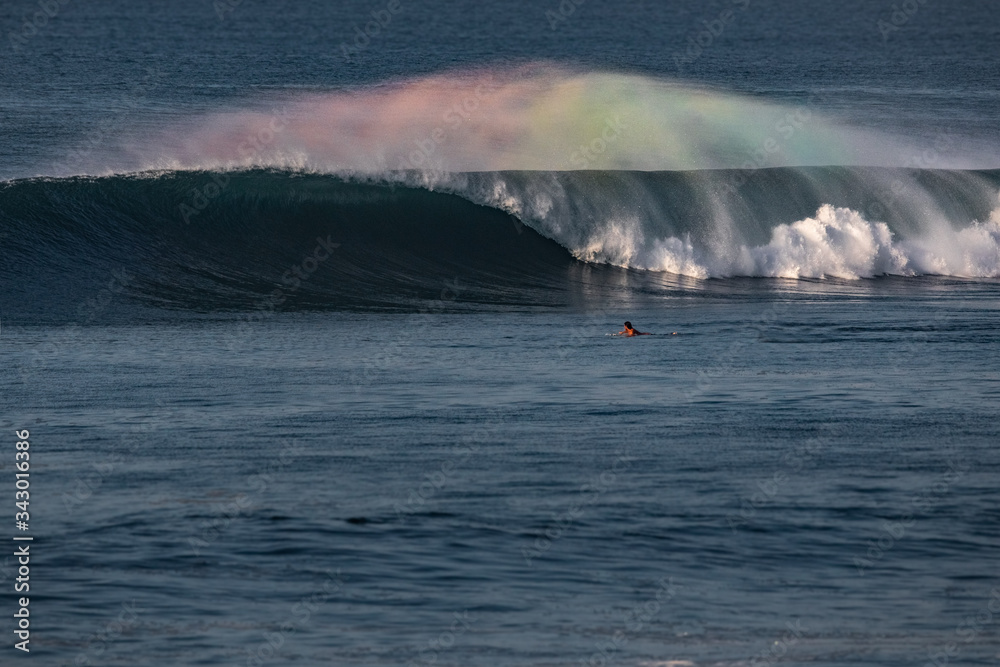 Man surfer swims towards the perfect wave. one of the most beautiful ...