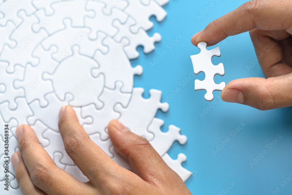 White jigsaw in the hands of humans, The correct solution. Teamwork ...