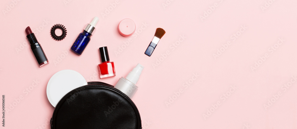 Top view of set of make up and skin care products spilling out of ...