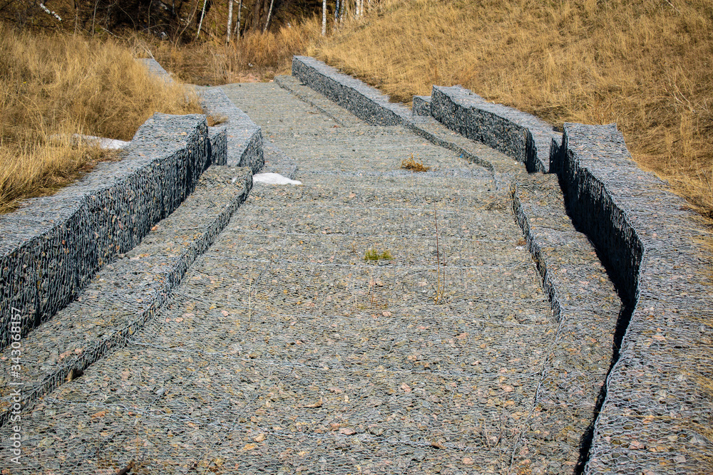 Dry channel bottom. Gabion structures made of stones and mesh. Dry ...