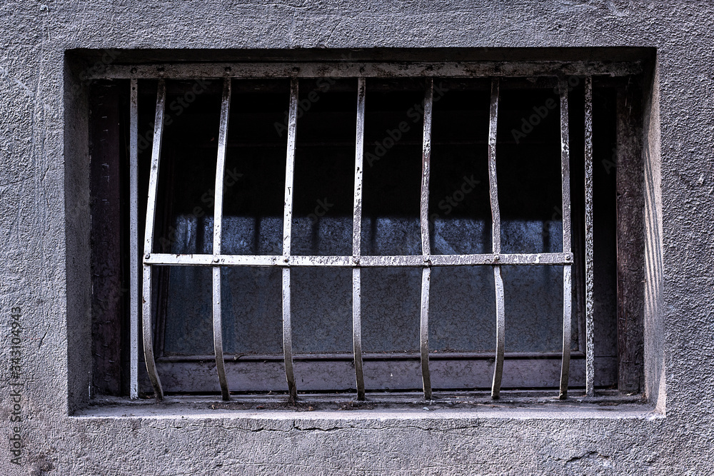 Dirty window with metal bars. Old wooden window with a metal grille ...
