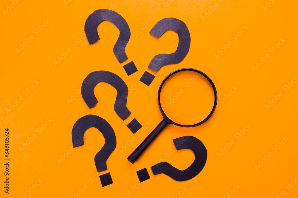 Magnifying Glass and Question Marks Stock Photo | Adobe Stock