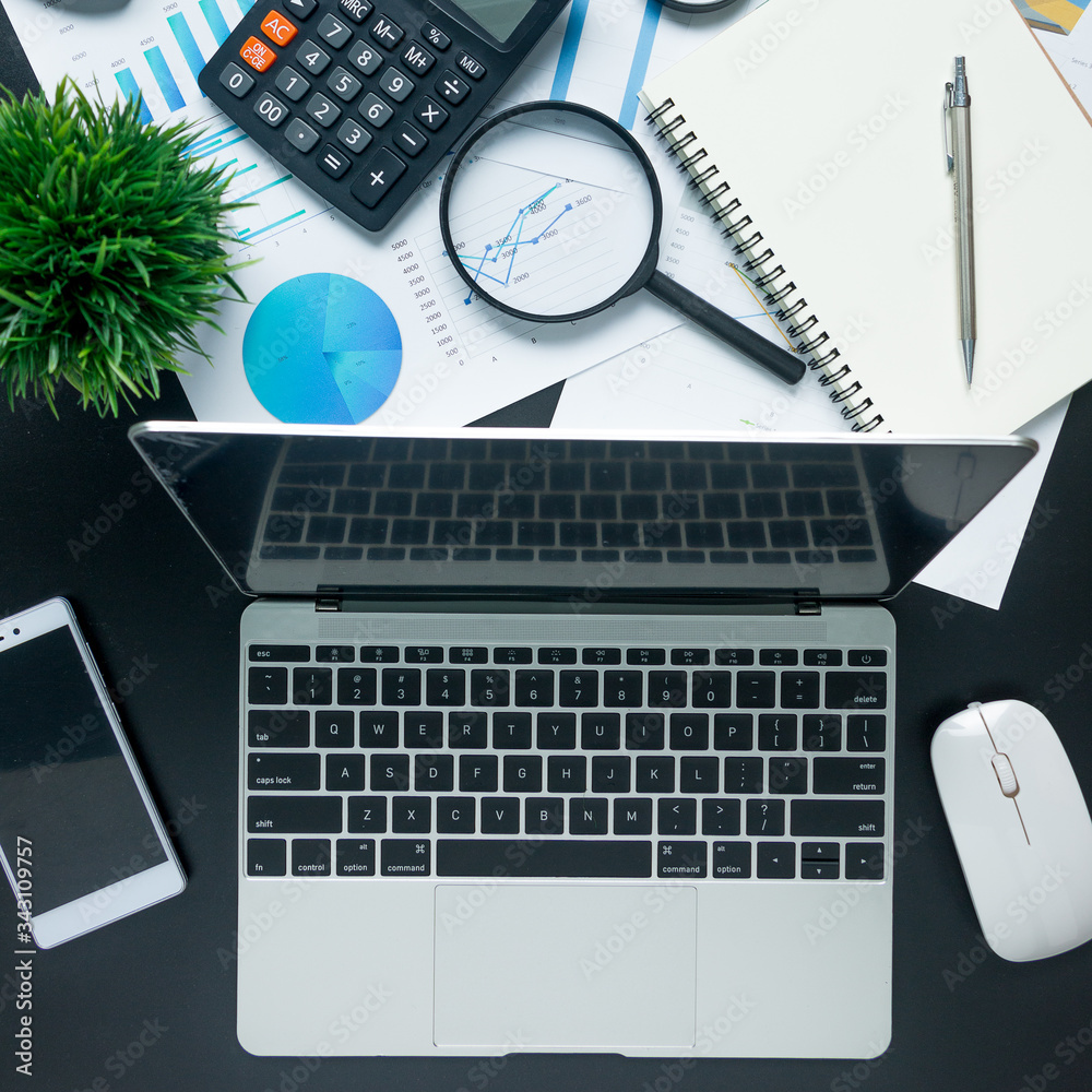 Top view, black desk with computer graph, magnifier and calculator Of ...