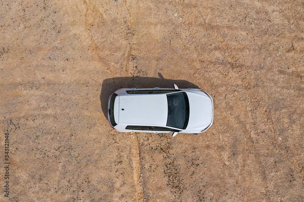 Small White Car parked in an off-road desert parking lot, Top down ...