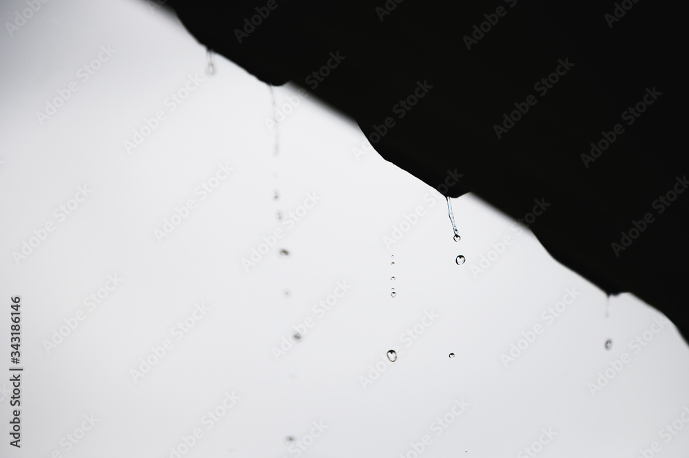 Falling rain from the roof,Drops of water flow into the eaves on the ...