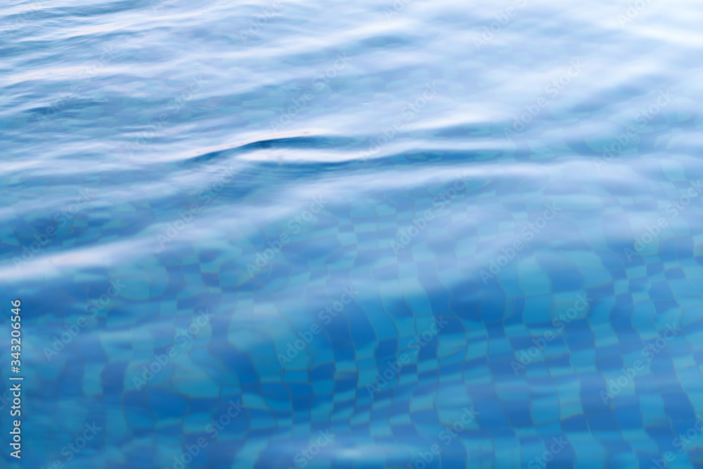 Blue wavy water in swimming pool with sun reflection. Mosaic background ...