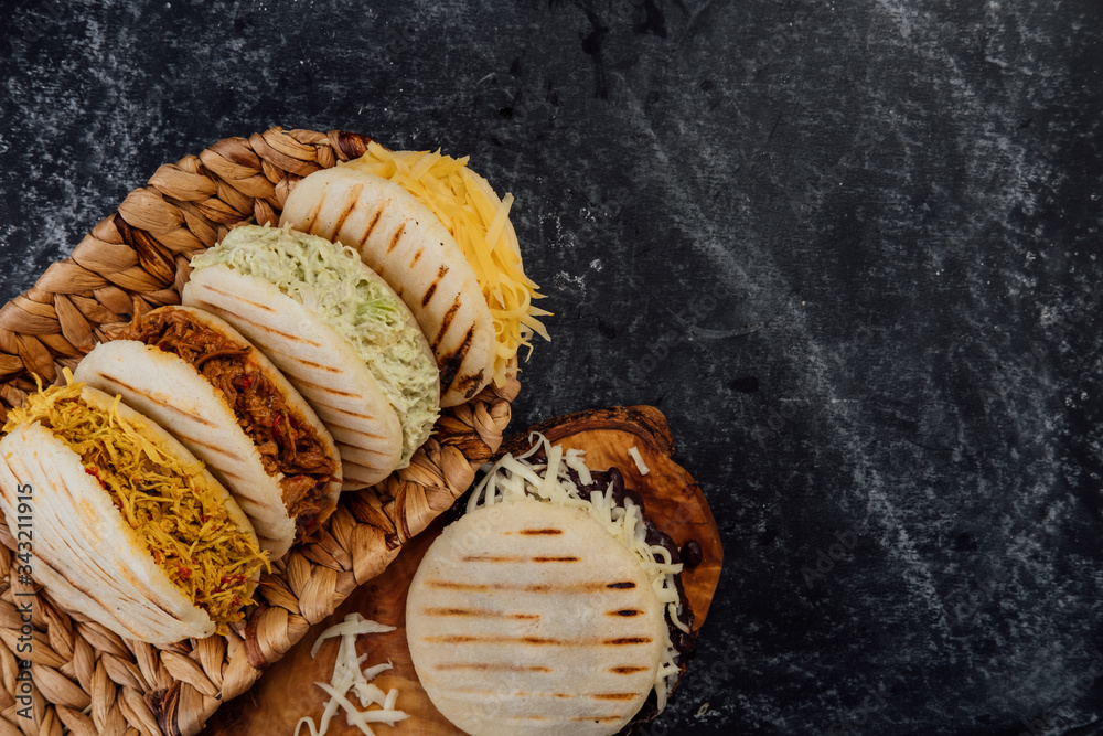 Top view of various types of typical Venezuelan arepas in a woven ...