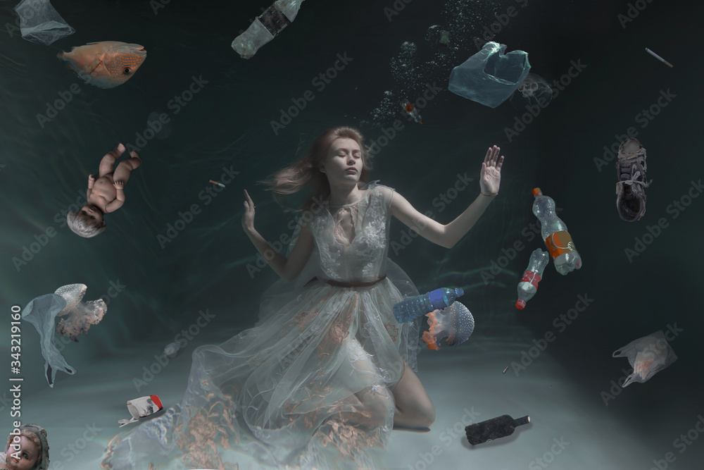 Ecological pollution of the planet and water. Garbage under water. Girl ...
