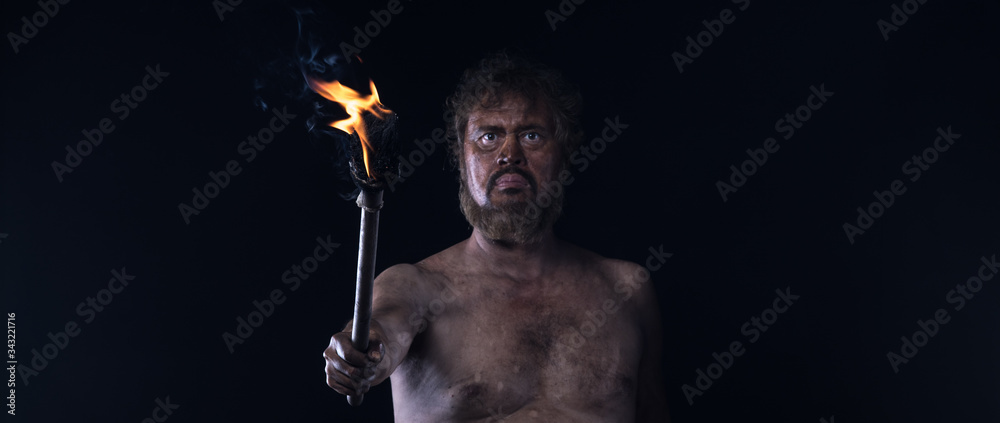 primitive caveman with a torch Stock Photo | Adobe Stock