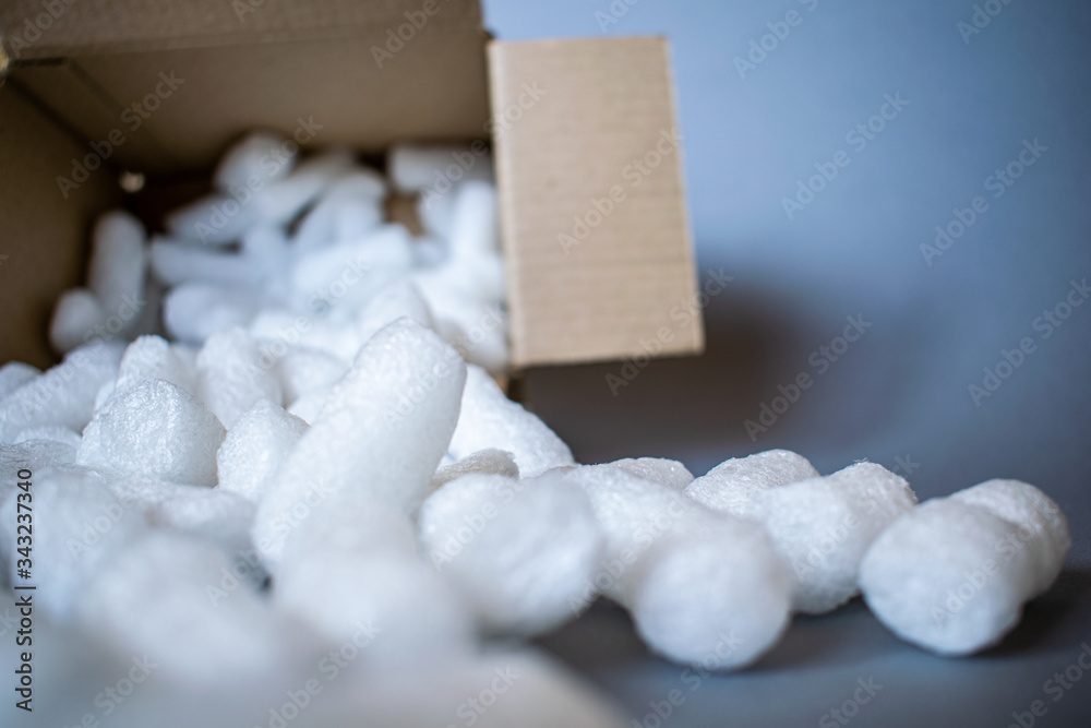 Open cardboard box with white styrofoam filling pieces comming out ...
