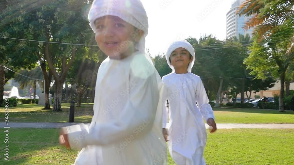 Kids playing outdoor on the meadow. Children wearing traditional united ...