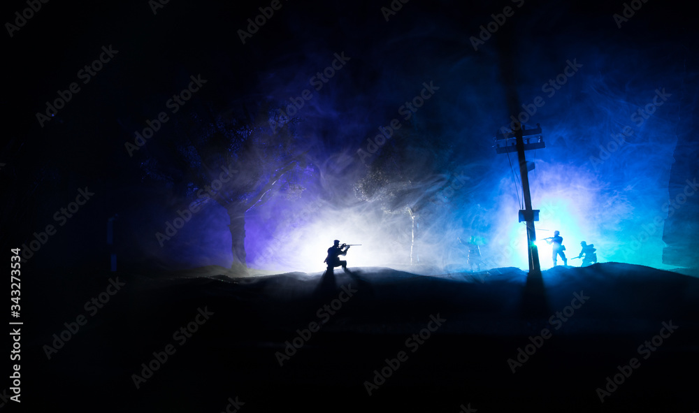 Army sniper with large caliber rifle standing in the fire and smoke ...