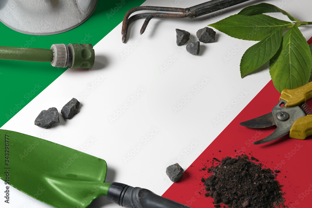 Italy flag with gardening tools background on table. Spring in the ...