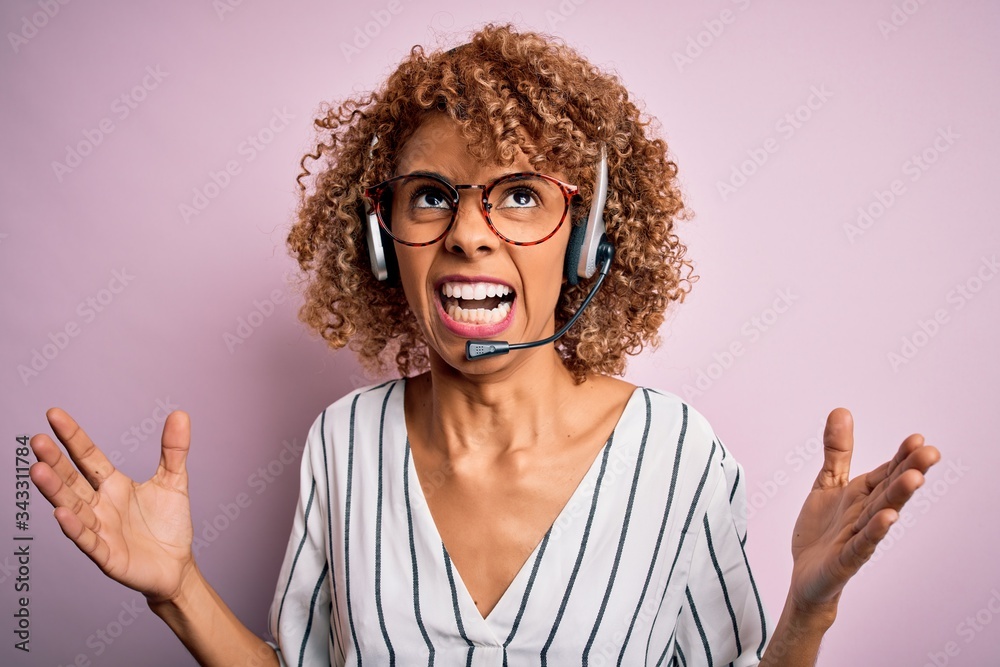 African american curly call center agent woman working using headset ...