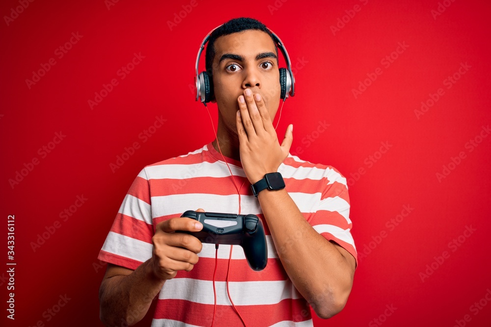 Handsome african american gamer man playing video game using jostick ...