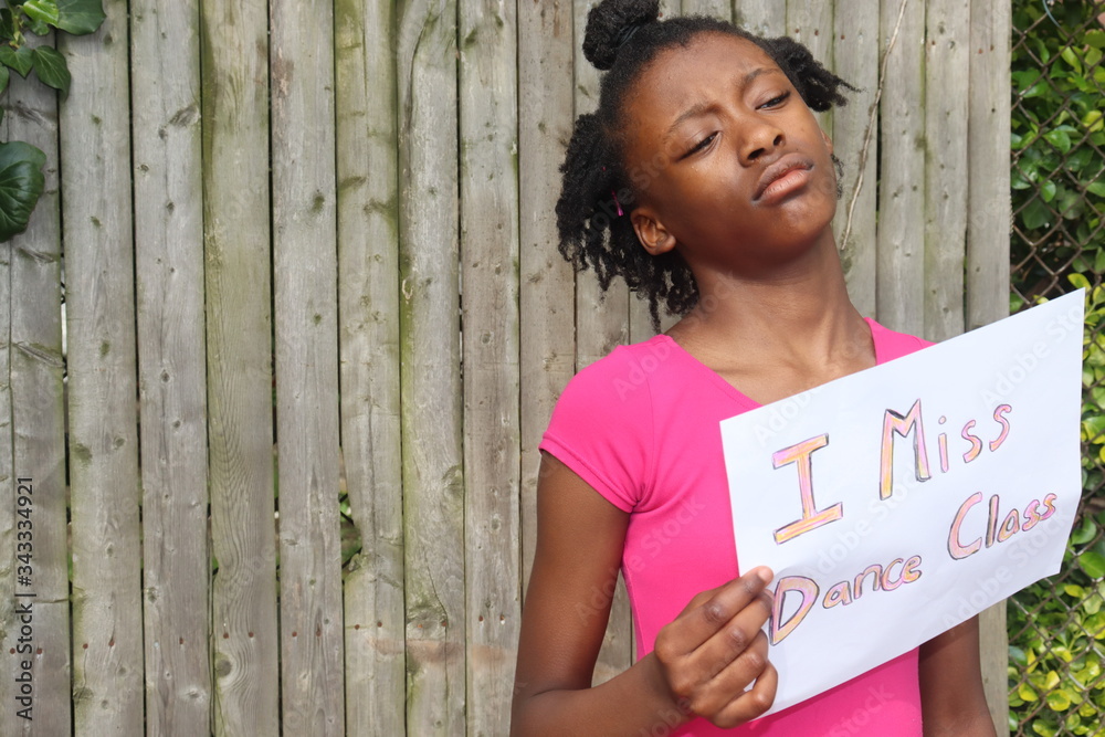 Sad Girl outdoors hold I Miss Dance Class homemade sign wearing pink ...