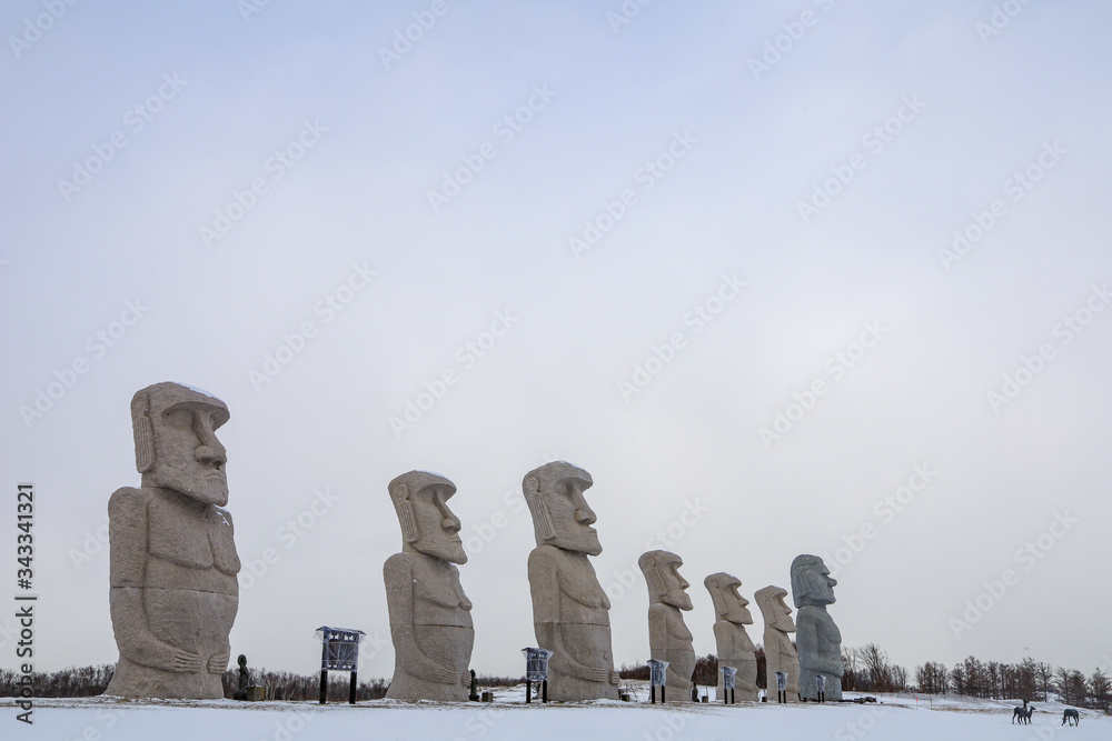 Moai, big stone statue in winter with snow on ground at hill of Budha ...