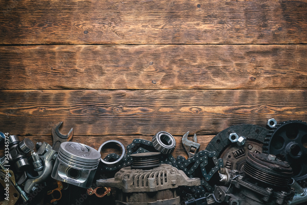 Old car spare parts on wooden flat lay workbench background with copy ...